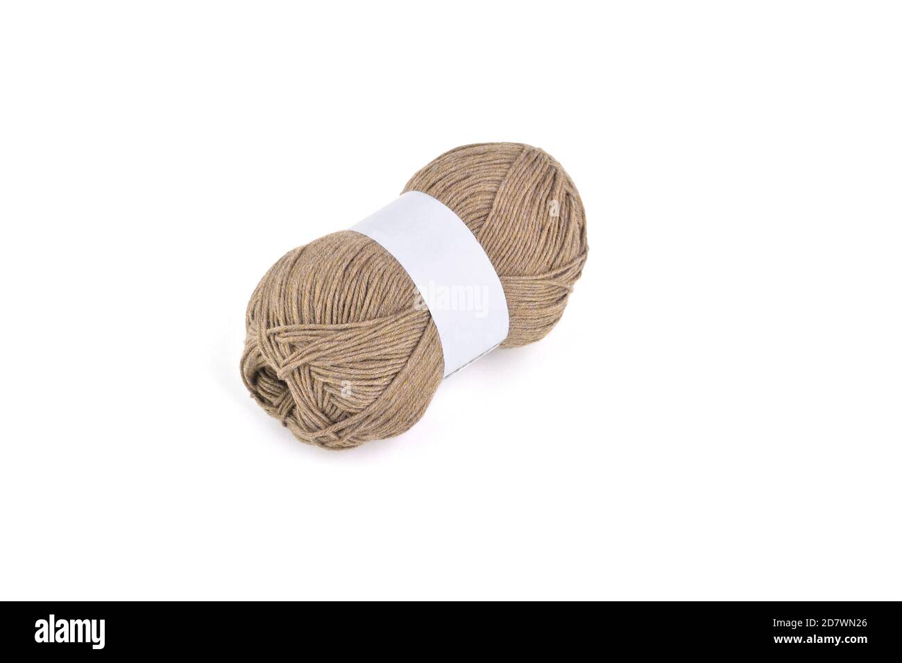 Tangle of beige color yarn with blank label on white background skein ...
