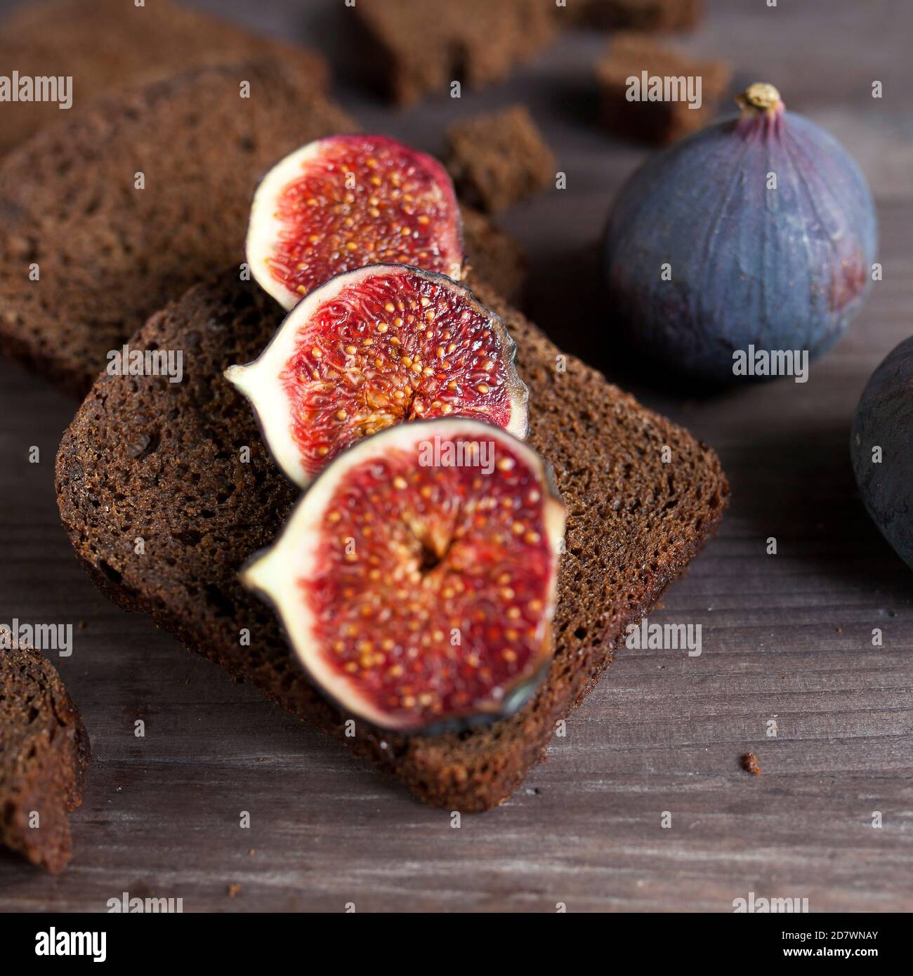 Bunch of fresh ripe figs on wodden brown background. Tropical fruit ...