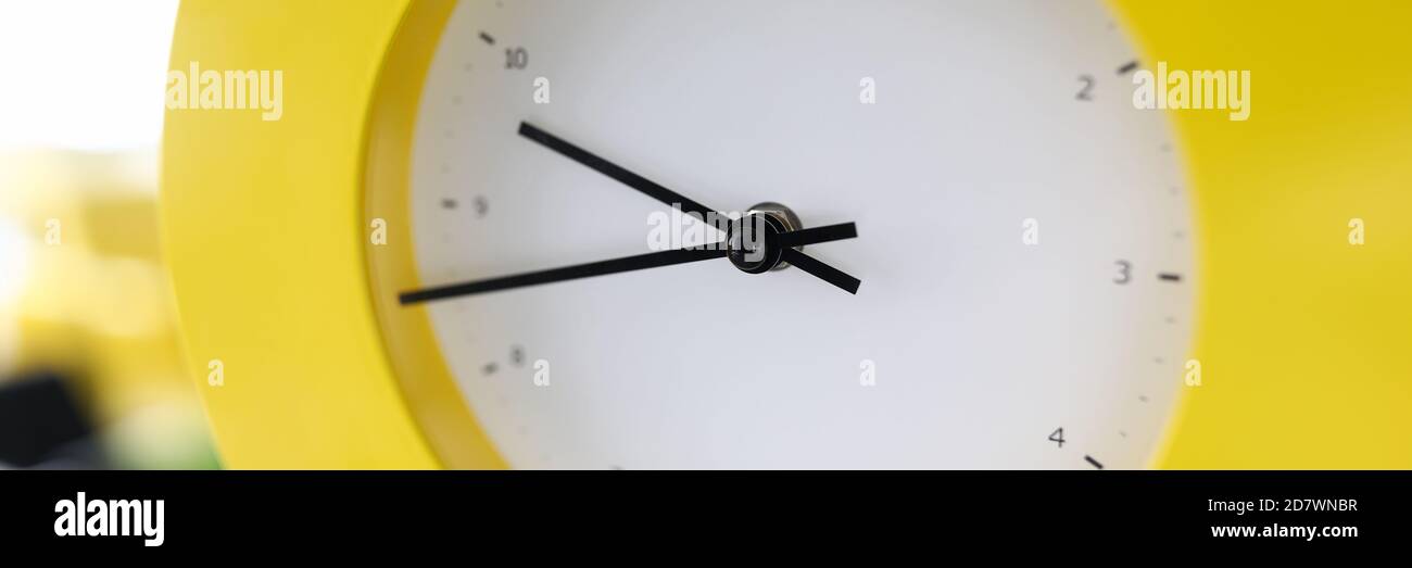 Beautiful yellow clock stands the table close-up Stock Photo - Alamy