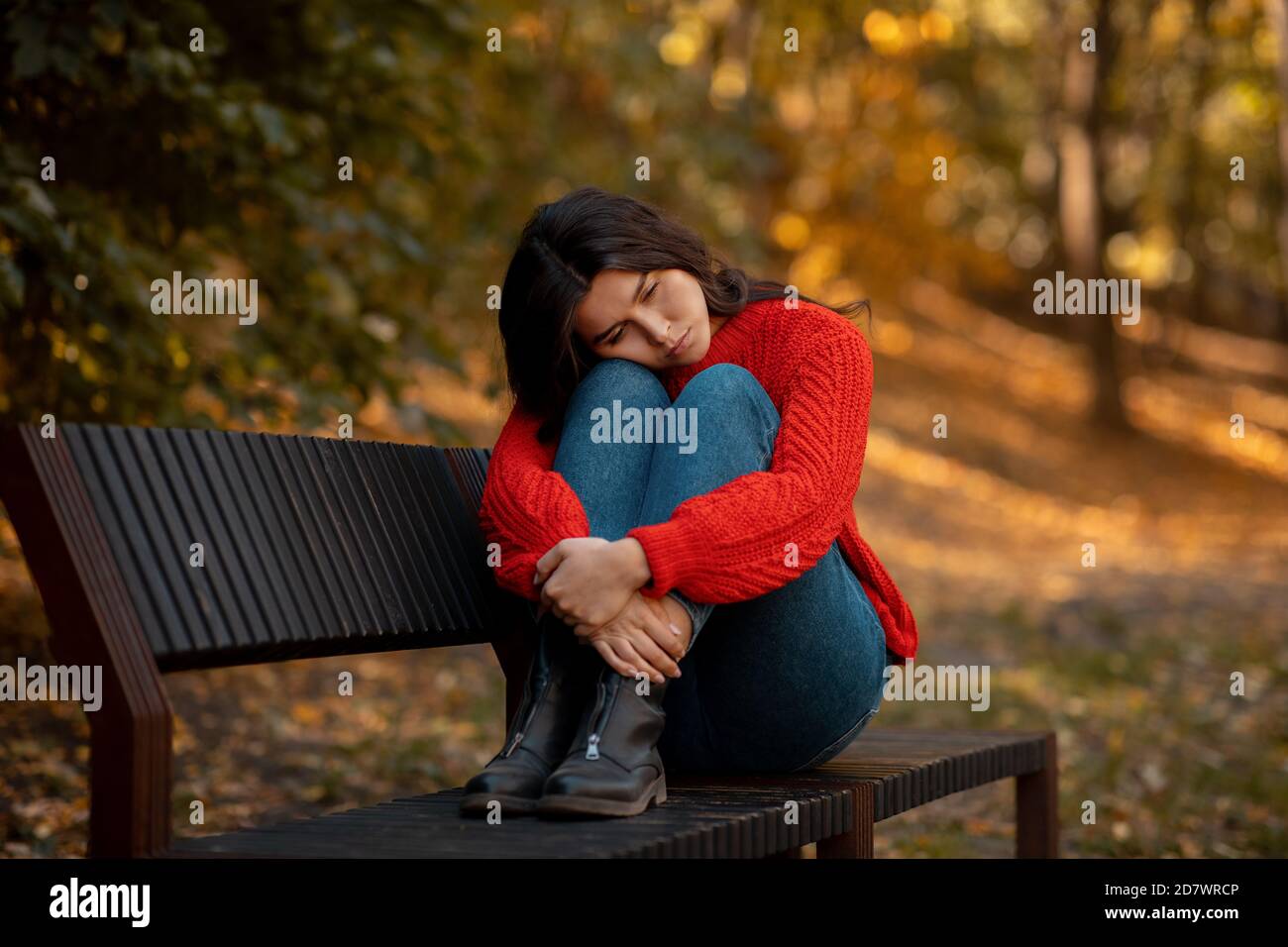 Woman hugging her knees hi-res stock photography and images - Alamy