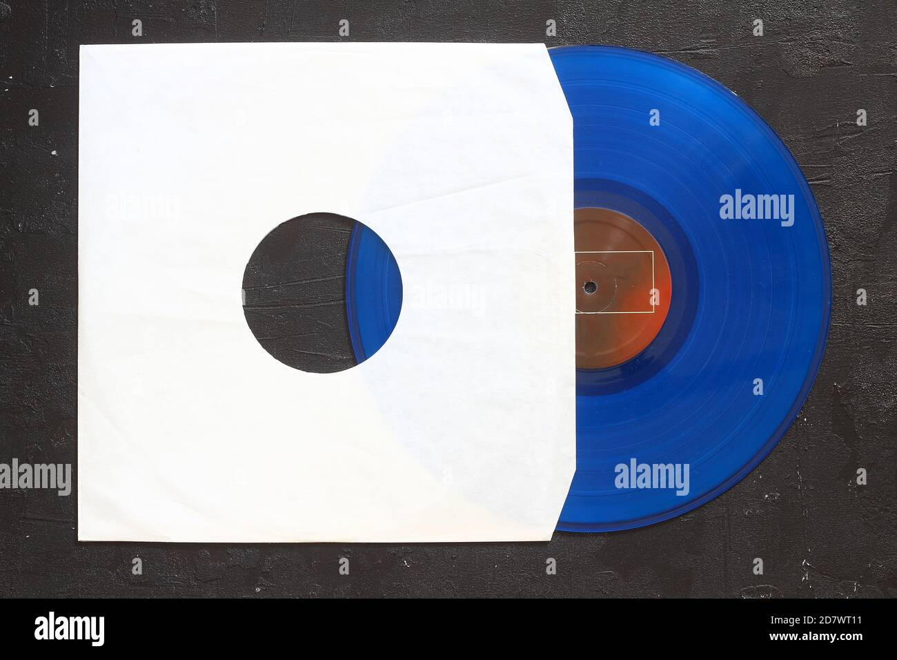 Aged black paper cover and blue vinyl LP record isolated on black ...