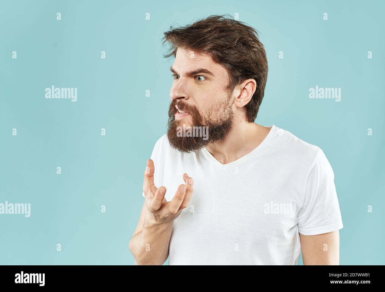 Aggressive man with a beard on a blue background cropped view Stock ...