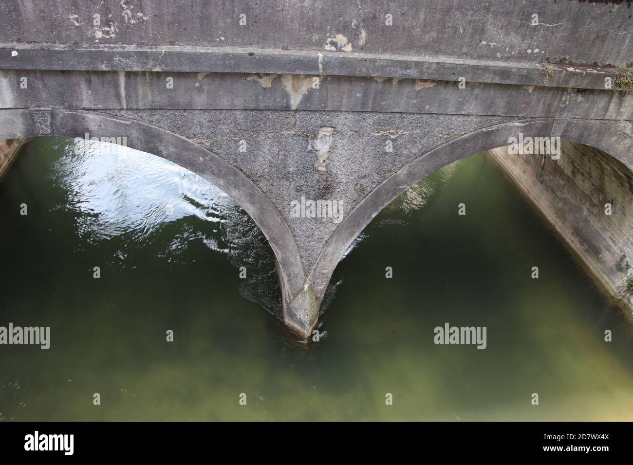 A very old stone bridge close up of the arch and under the bridge with ...