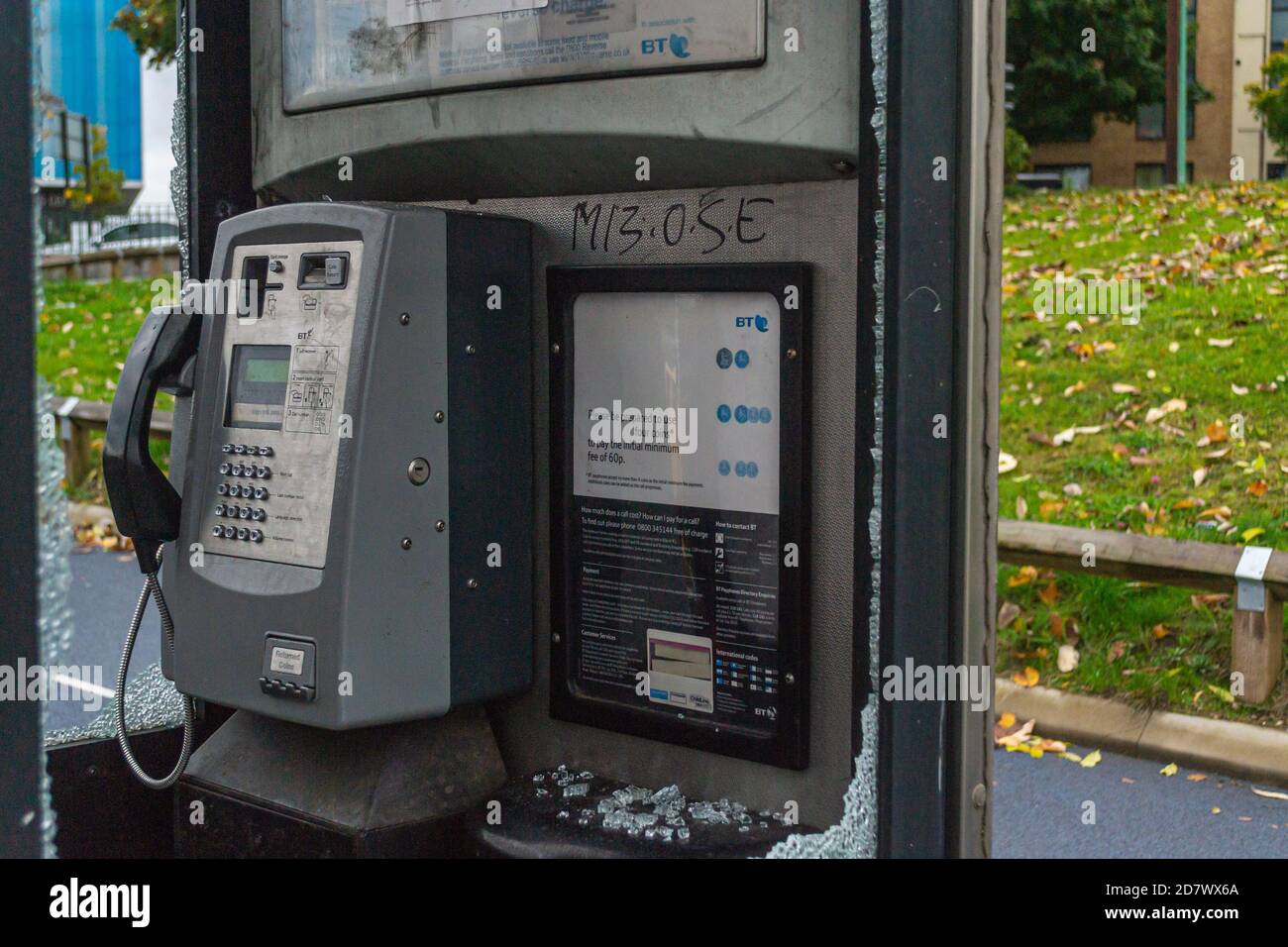 Smashed up, vandalised British telephone box with broken glass Stock ...