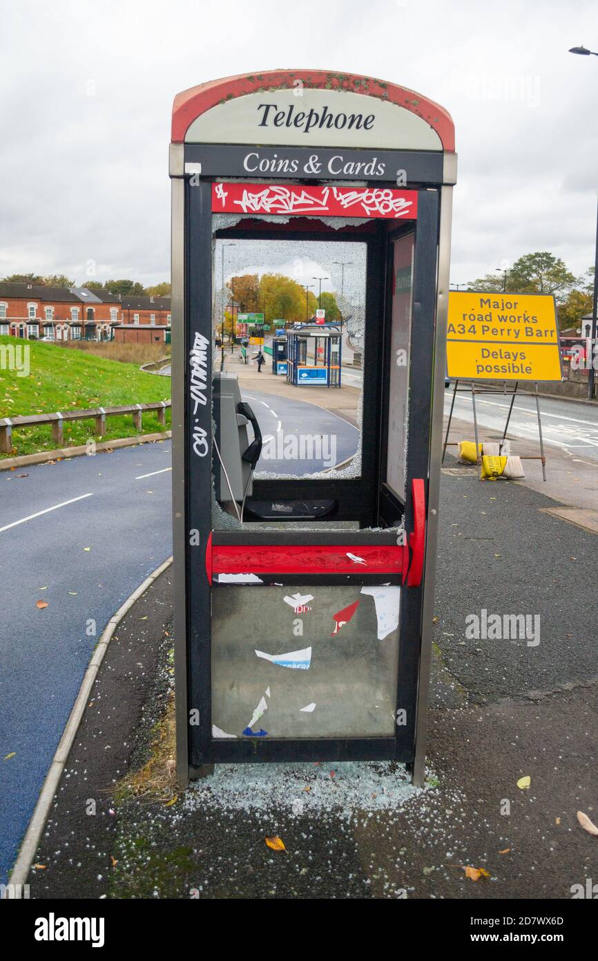 Smashed up, vandalised British telephone box with broken glass Stock ...