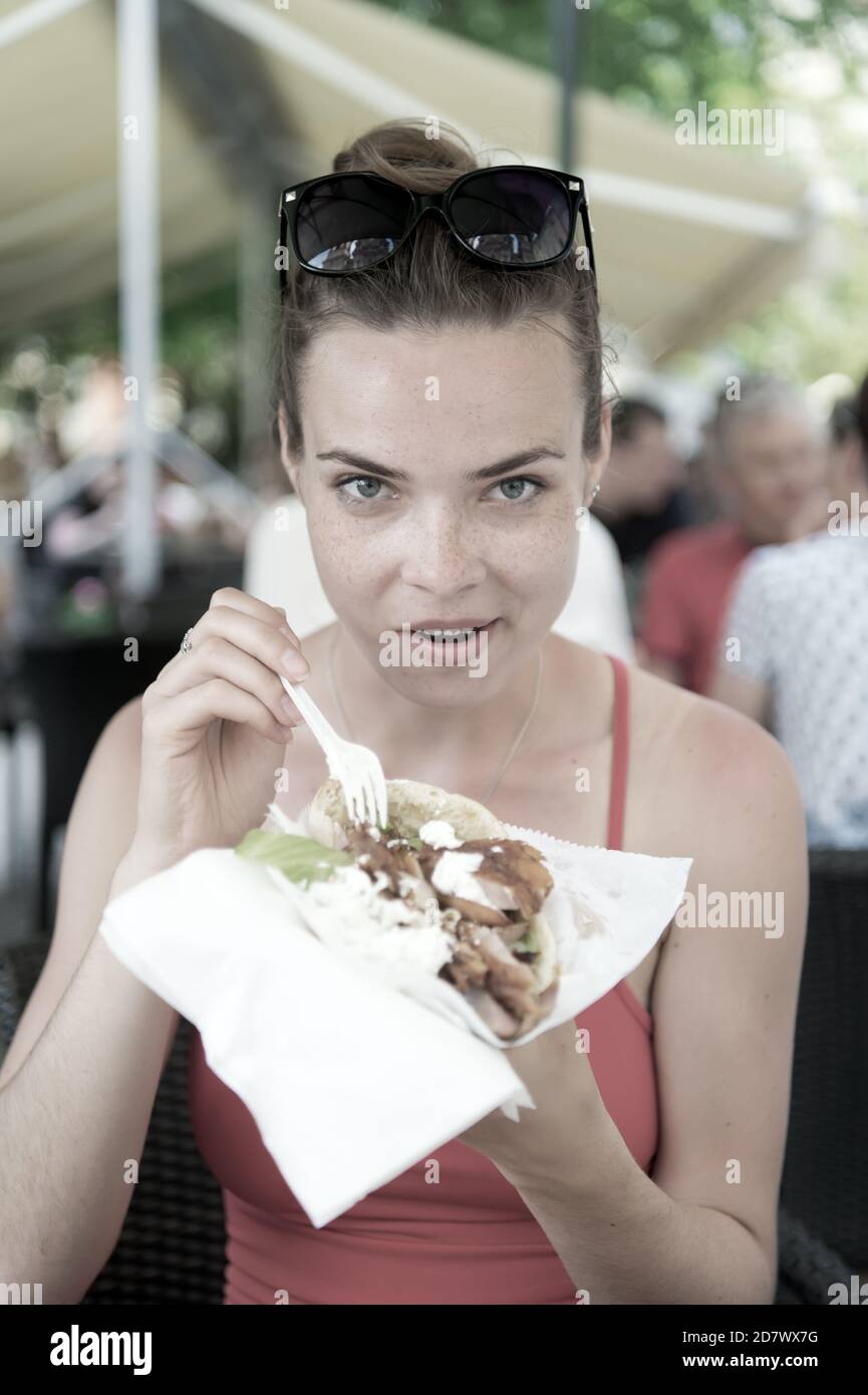 girl or Woman eating sandwich gyros. Girl with pleasure eats burger ...