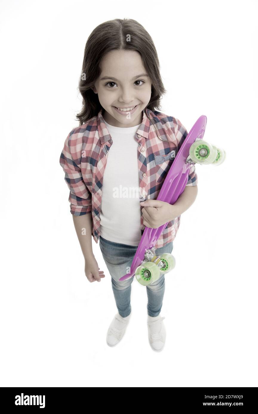 Fond of skateboarding. Kid girl happy carries penny board. Child likes ...
