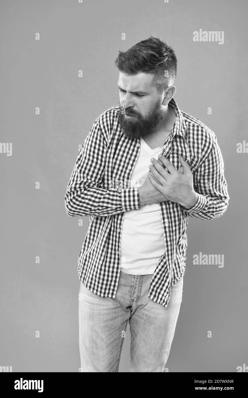 Oh my heart. Bearded man suffer from heart pain. Hipster hold hand on ...