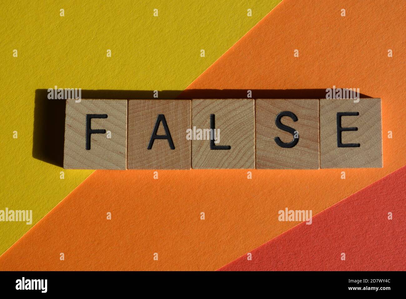 False, word in wooden alphabet letters isolated on colorful background ...