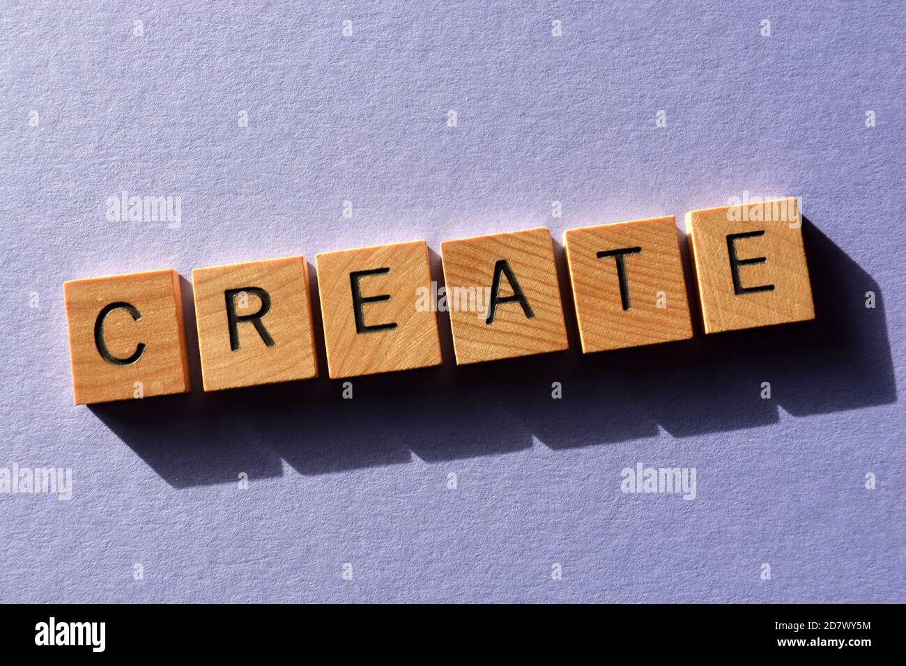 Create, word in wooden alphabet letters isolated on purple background ...