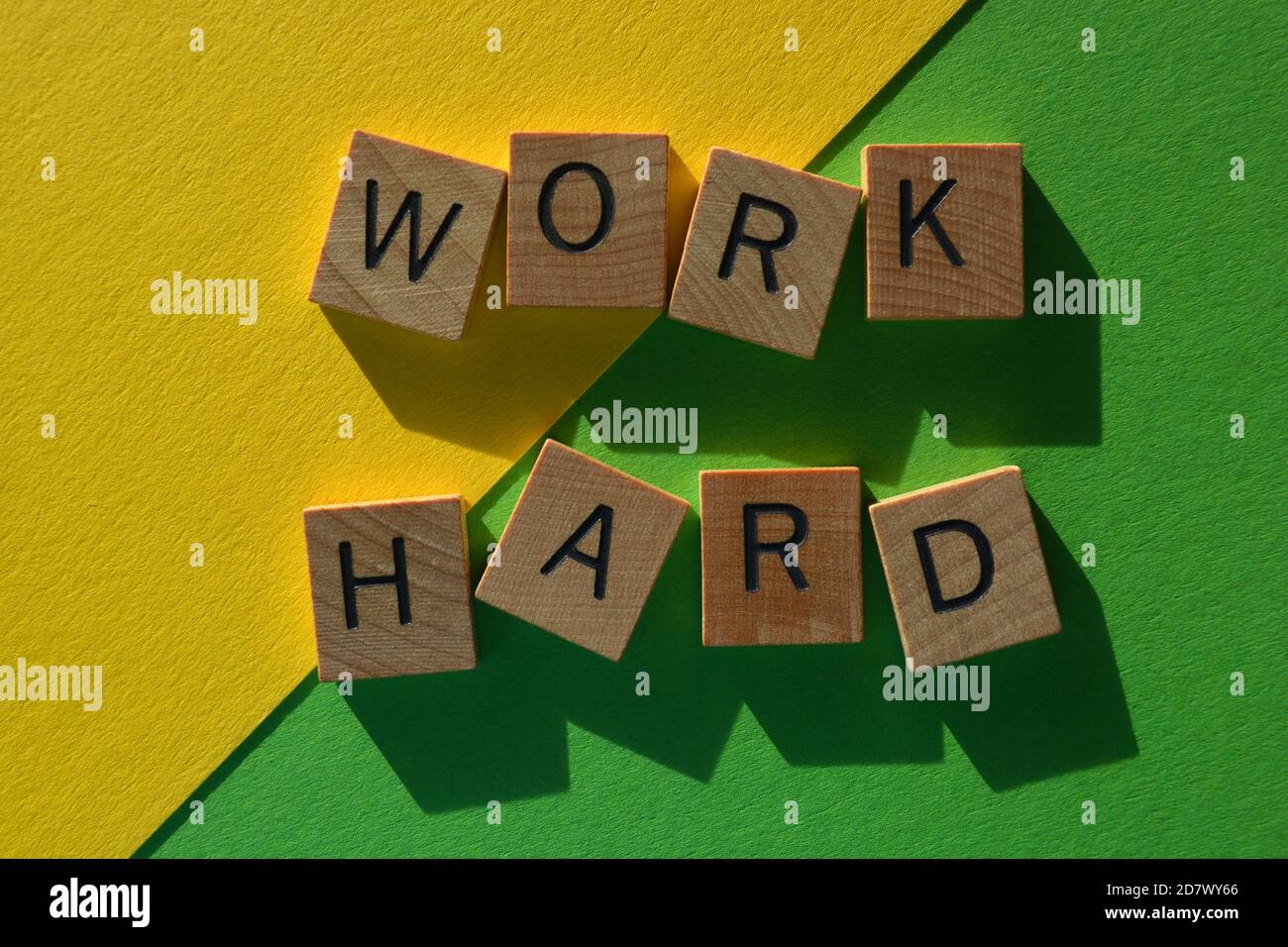 Work, Hard, words in wooden alphabet letters isolated on yellow and ...