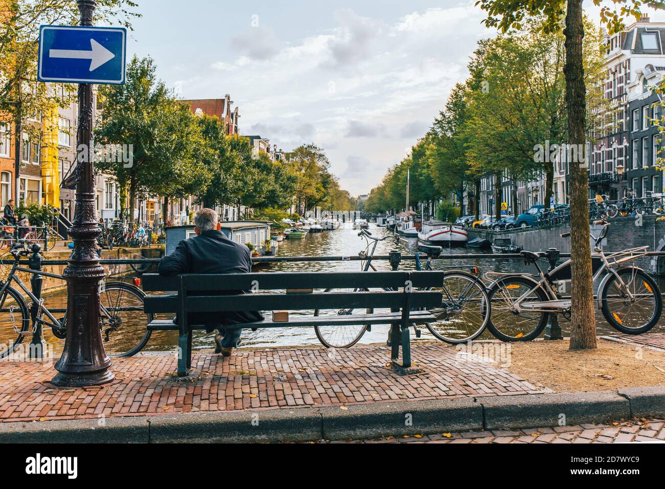 AMSTERDAM NETHERLANDS, SEPTEMBER 17, 2017: Man sitting on bench in ...