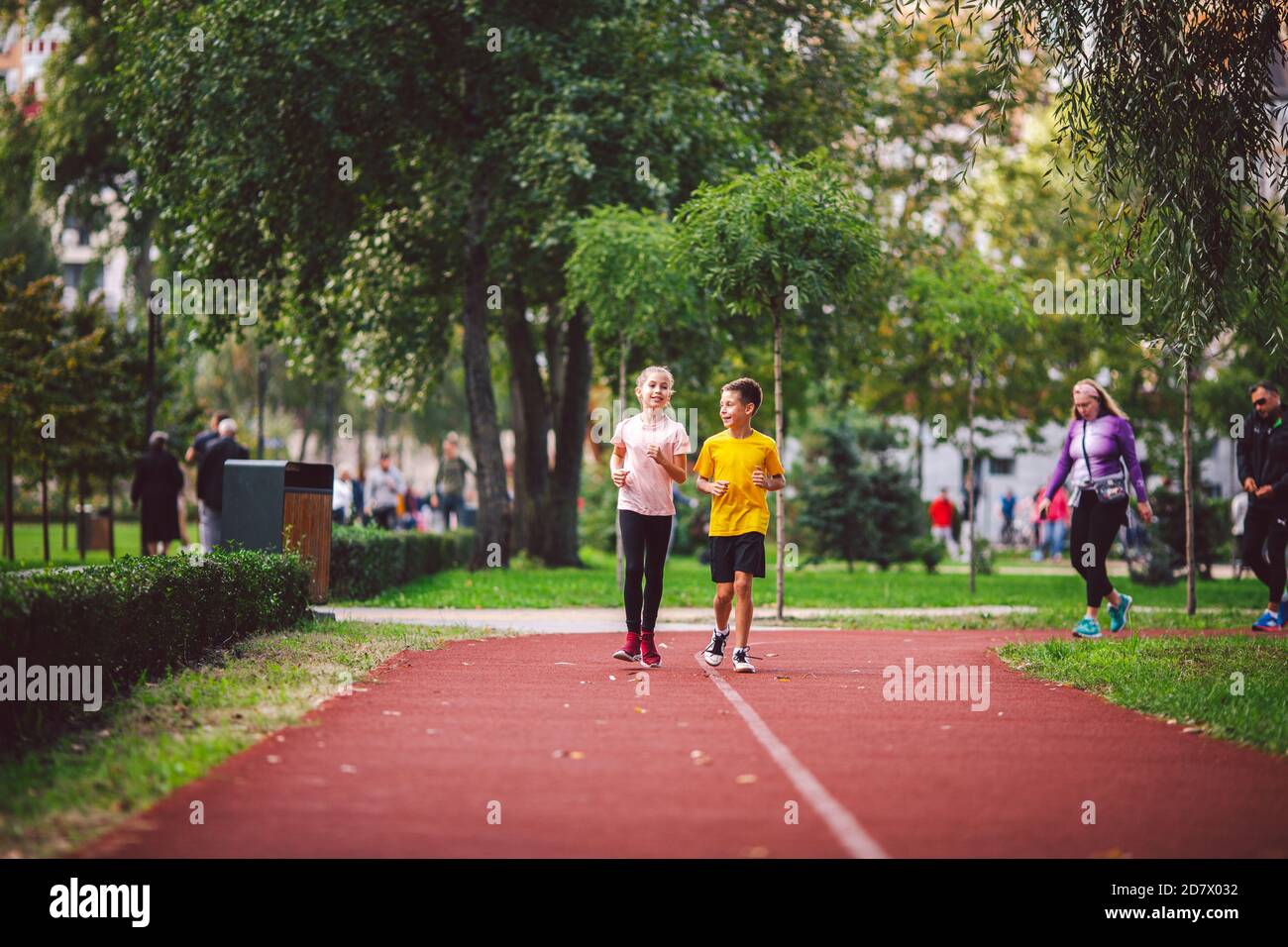 Child fitness, twins kids running on stadium track in city park ...