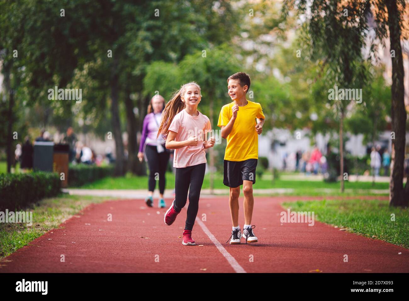 Child fitness, twins kids running on stadium track in city park ...