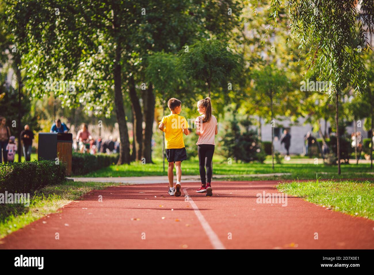 Child fitness, twins kids running on stadium track in city park ...