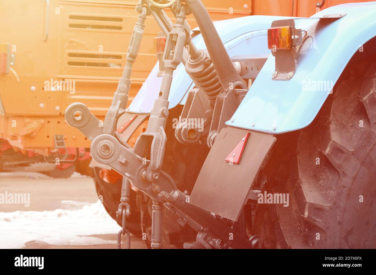 Wheels of back view of new tractor in snowy weather. Agricultural ...