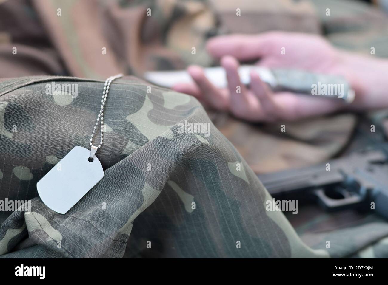 Empty army token of dead military soldier lies on camouflage clothes ...