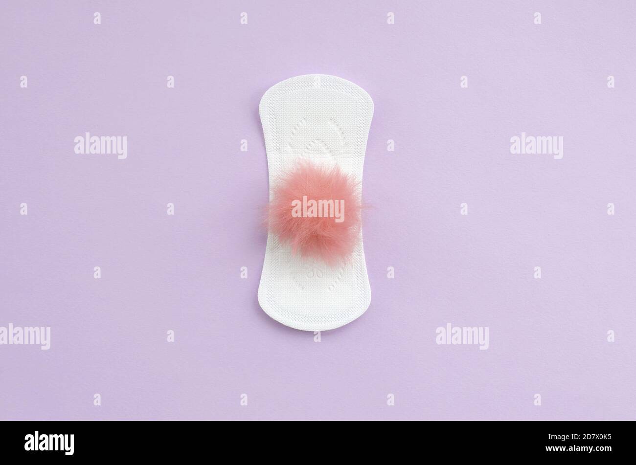 Menstrual pad and red fluffy fuzzy as a blood on violet pastel ...
