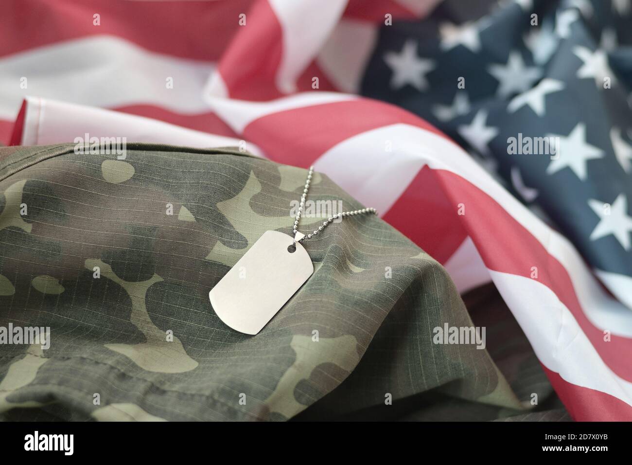 Silvery military beads with dog tag on United States fabric flag and ...