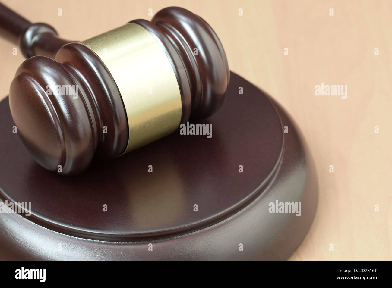 Justice mallet on wooden desk in a courtroom during a judicial trial. Law concept and empty copy ...