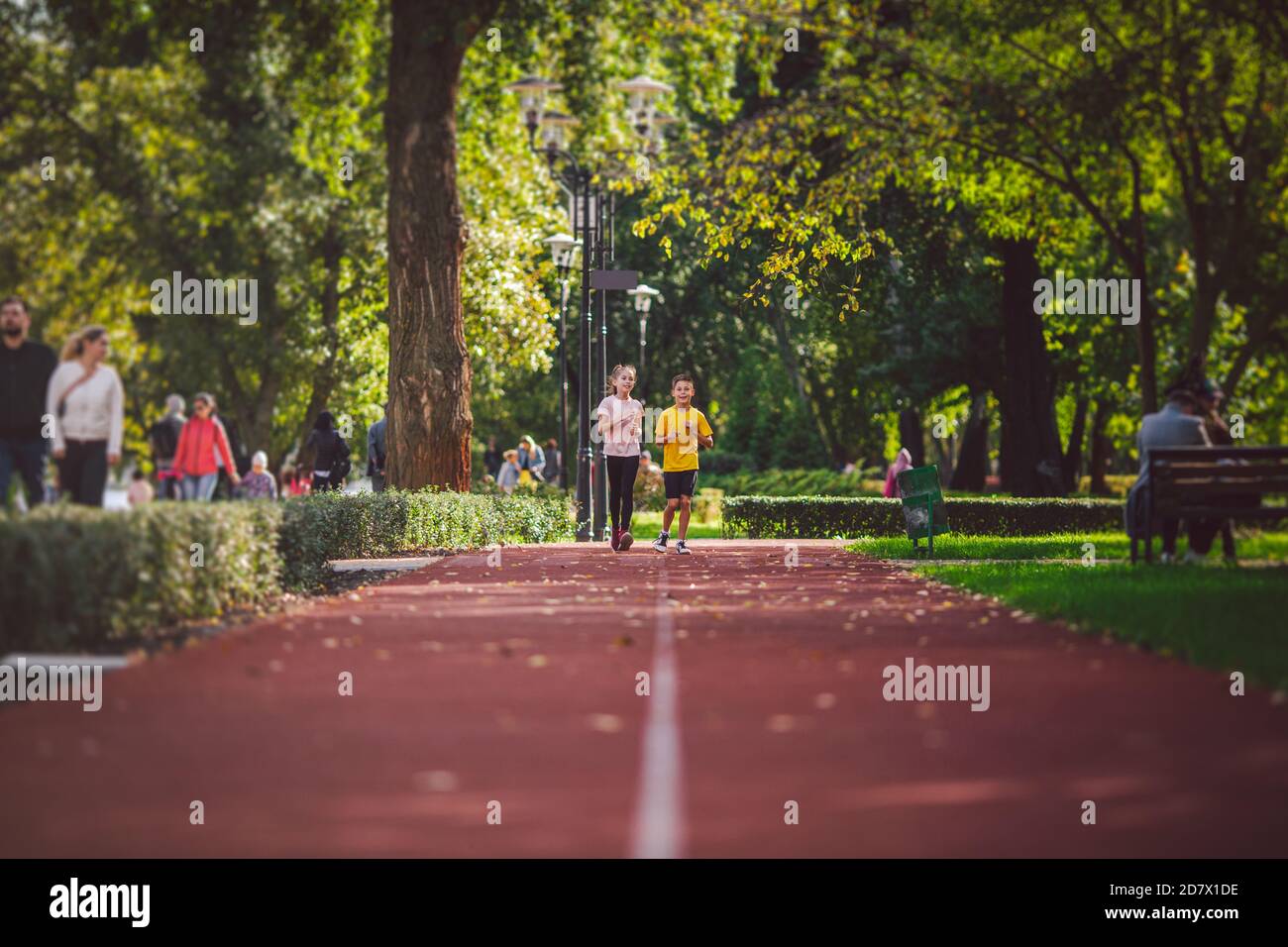 Sports and fitness in adolescence. Caucasian twins boy and girl run on ...