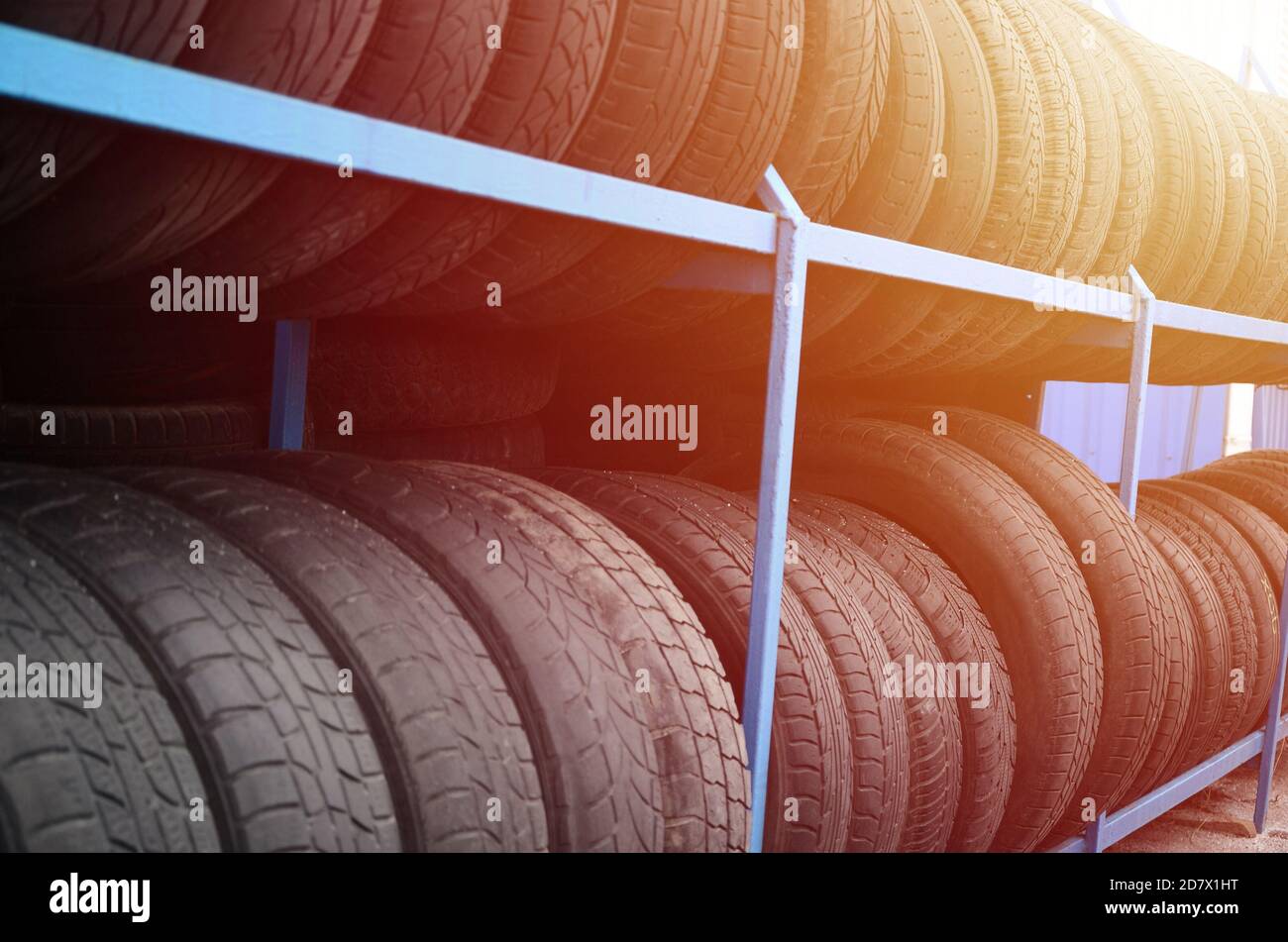 Rack with variety of car tires in automobile store. Many black tires ...