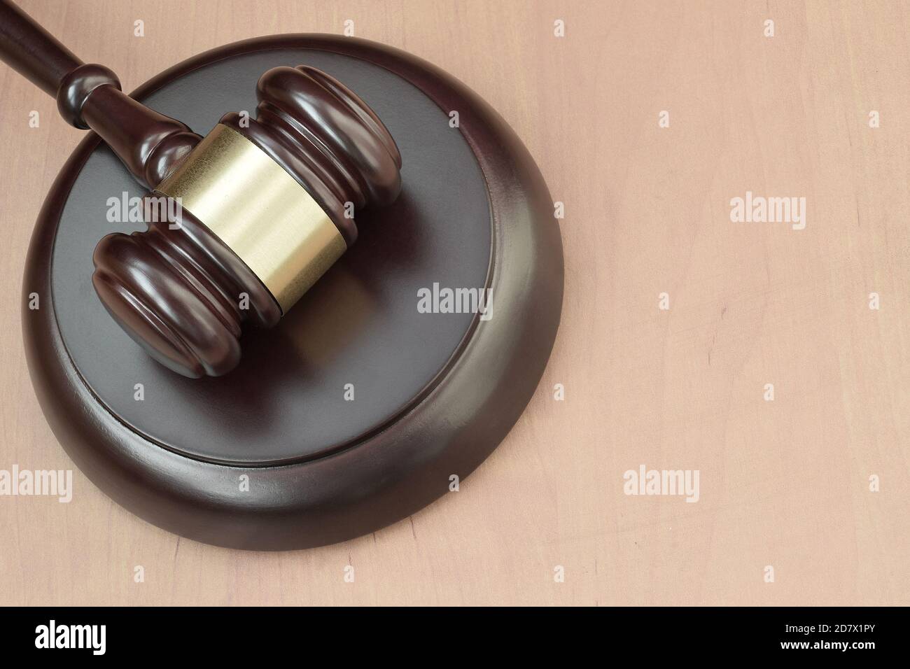 Justice mallet on wooden desk in a courtroom during a judicial trial. Law concept and empty copy ...