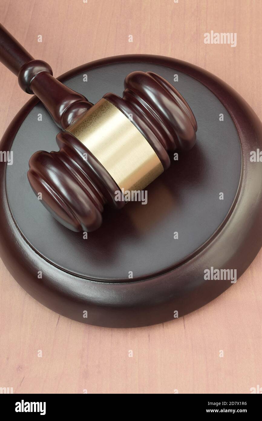 Justice mallet on wooden desk in a courtroom during a judicial trial. Law concept and empty copy ...