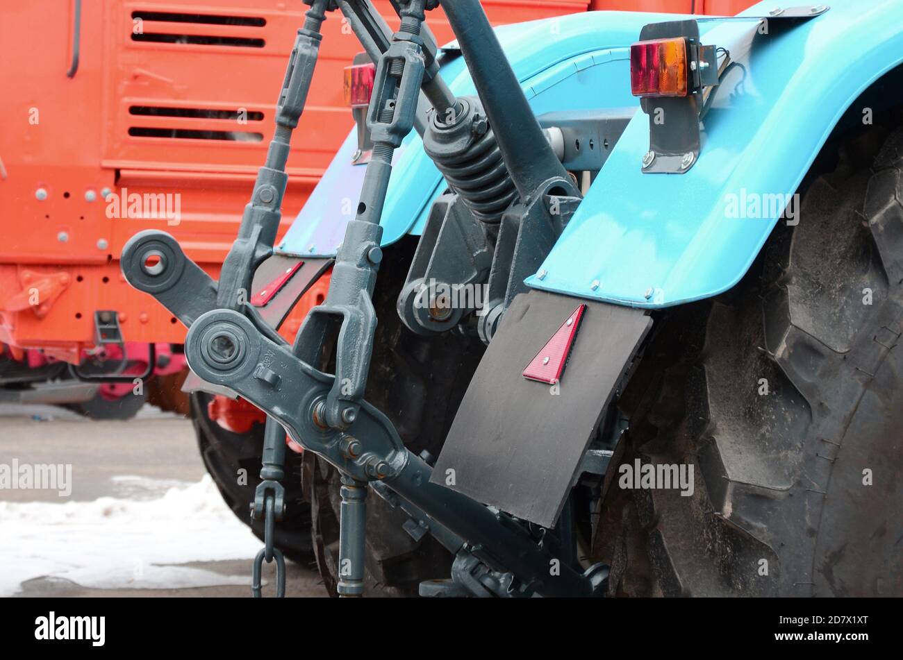 Wheels of back view of new tractor in snowy weather. Agricultural ...
