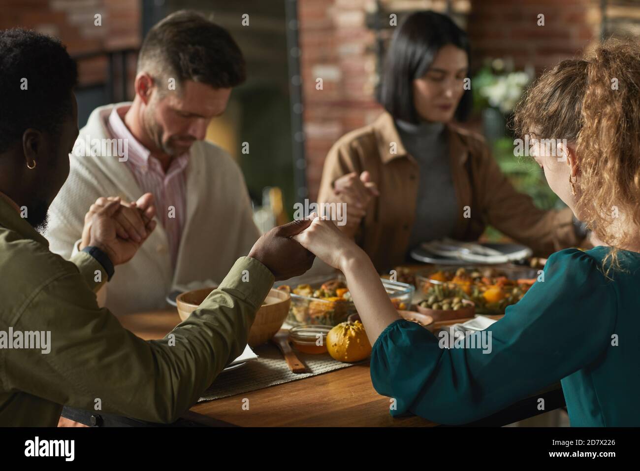 Young woman praying hands table hi-res stock photography and images - Alamy