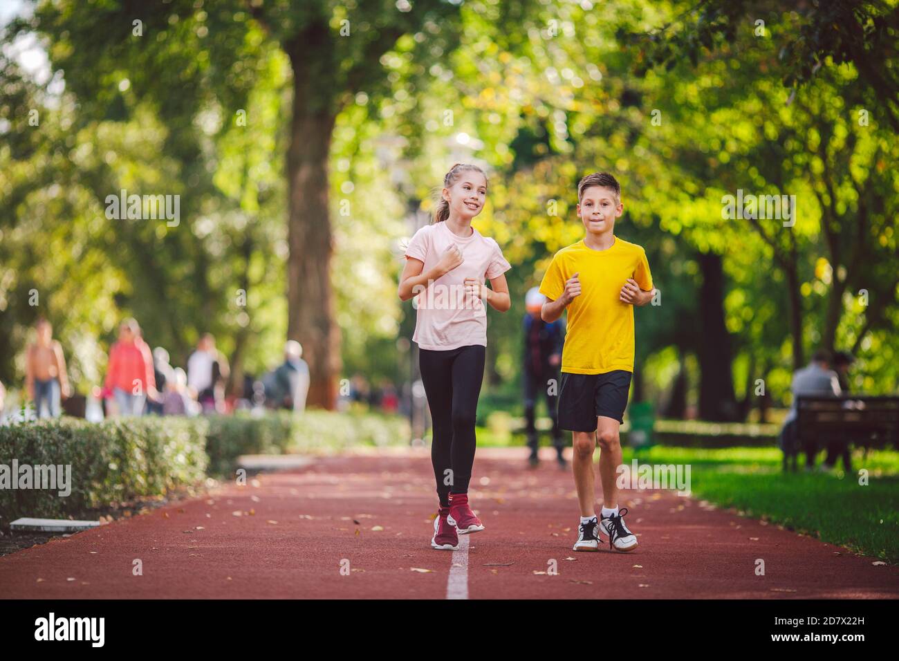 Child fitness, twins kids running on stadium track in city park ...