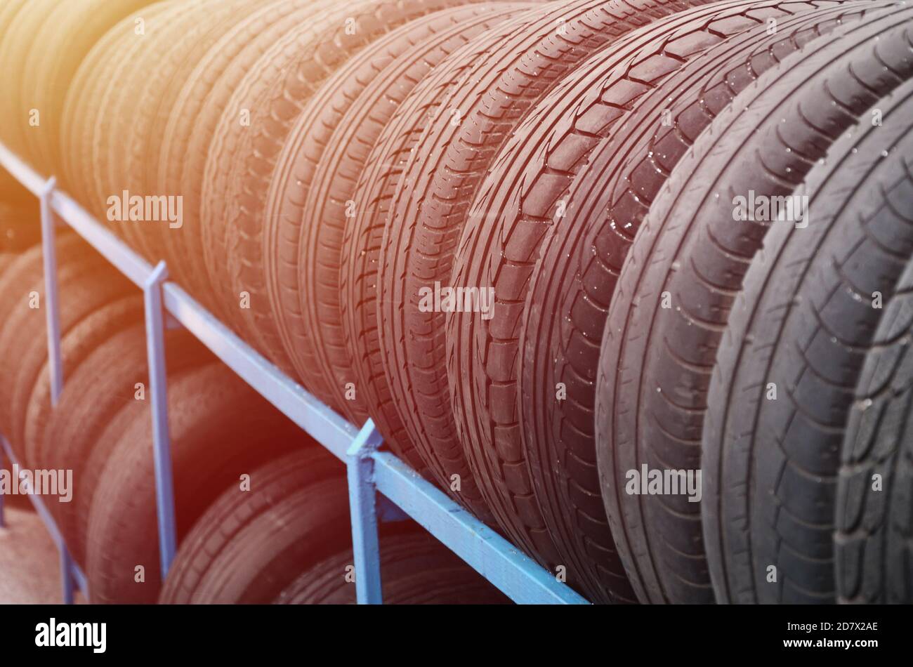 Rack with variety of car tires in automobile store. Many black tires ...