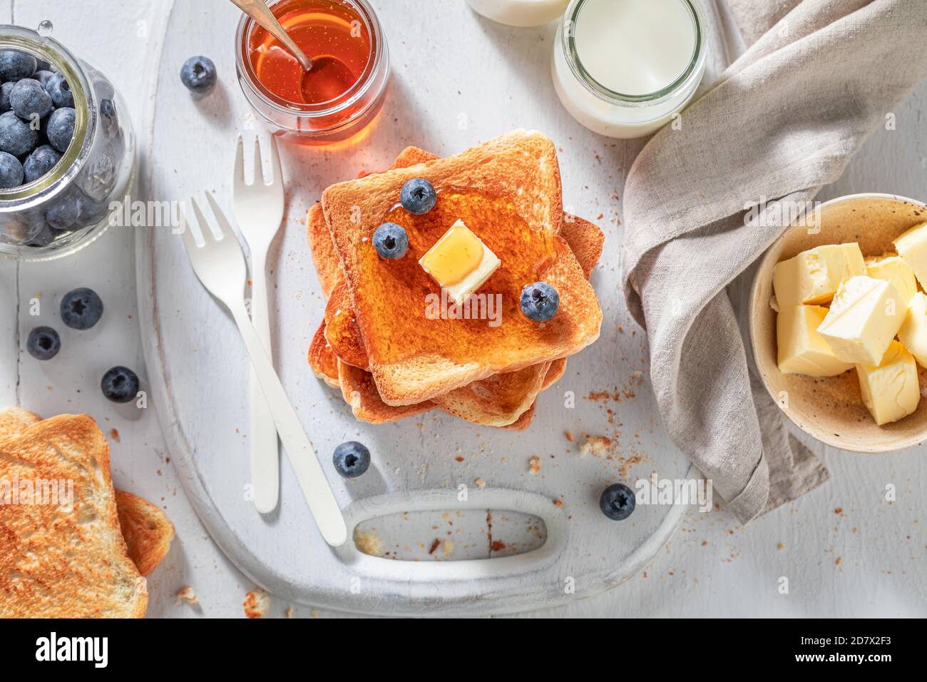 Homemade french toast with fresh berries and honey on white table Stock ...