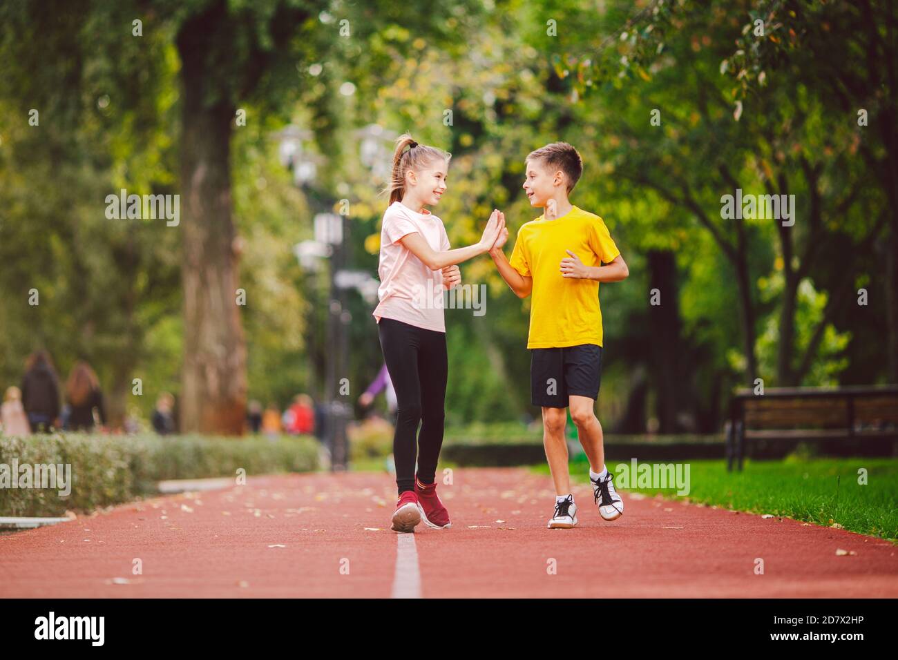 Child fitness, twins kids running on stadium track in city park ...