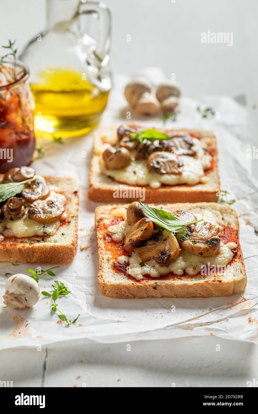 Rustic Toast made of mushrooms, cheese and pepper on white paper Stock ...