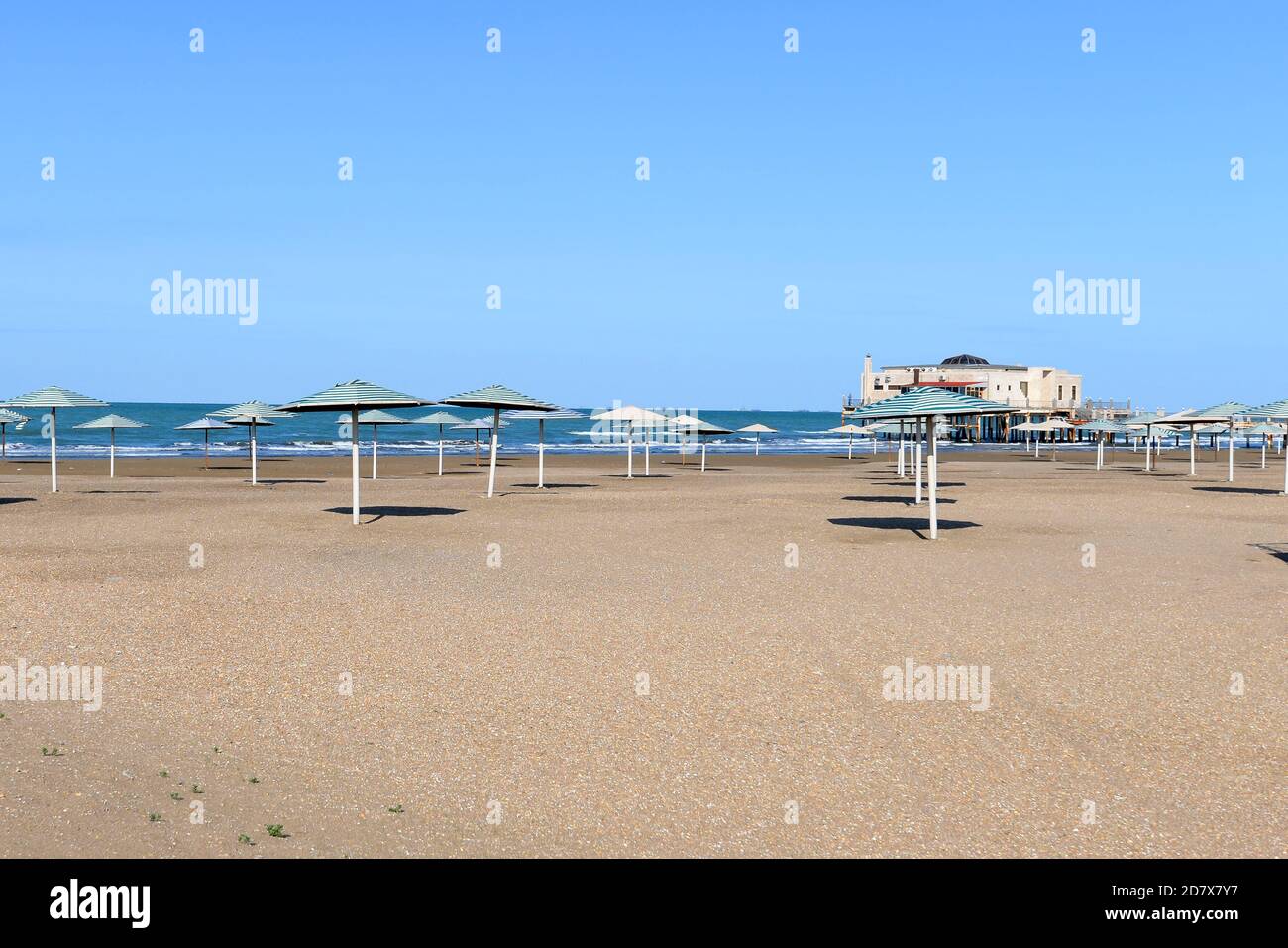 Shebeke Beach in the Caspian Sea, Azerbaijan. Multiple umbrellas at ...