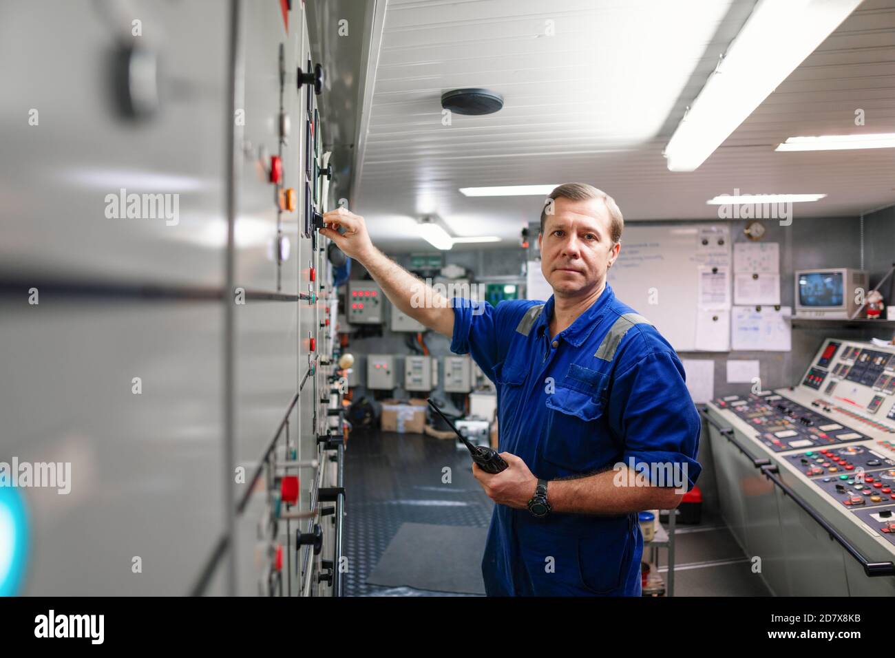 Marine engineer officer controlling vessel engines and propulsion in ...