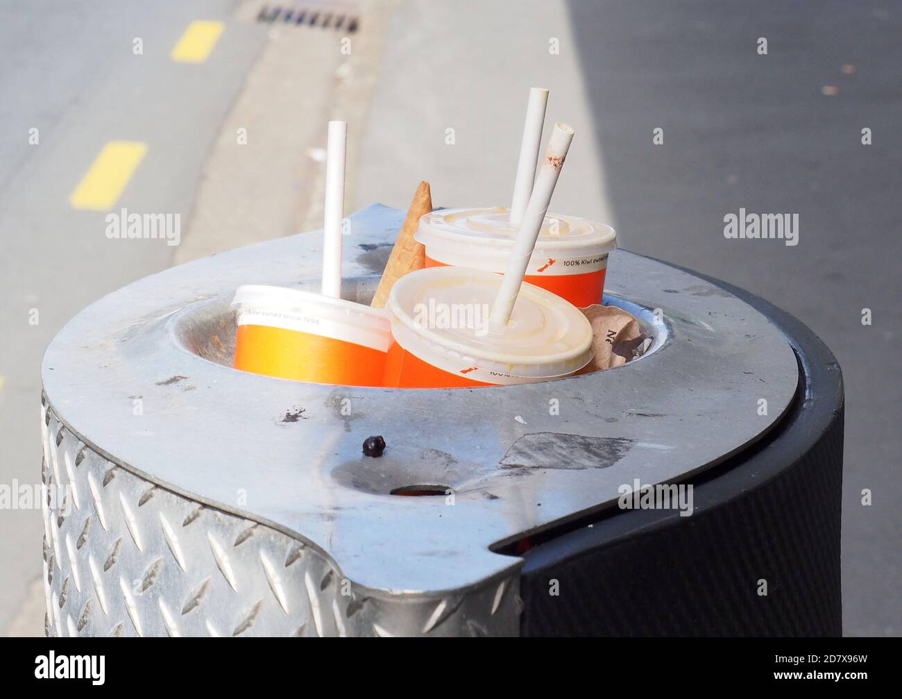 Single use plastic drink containers with straws, dumped in a full city ...