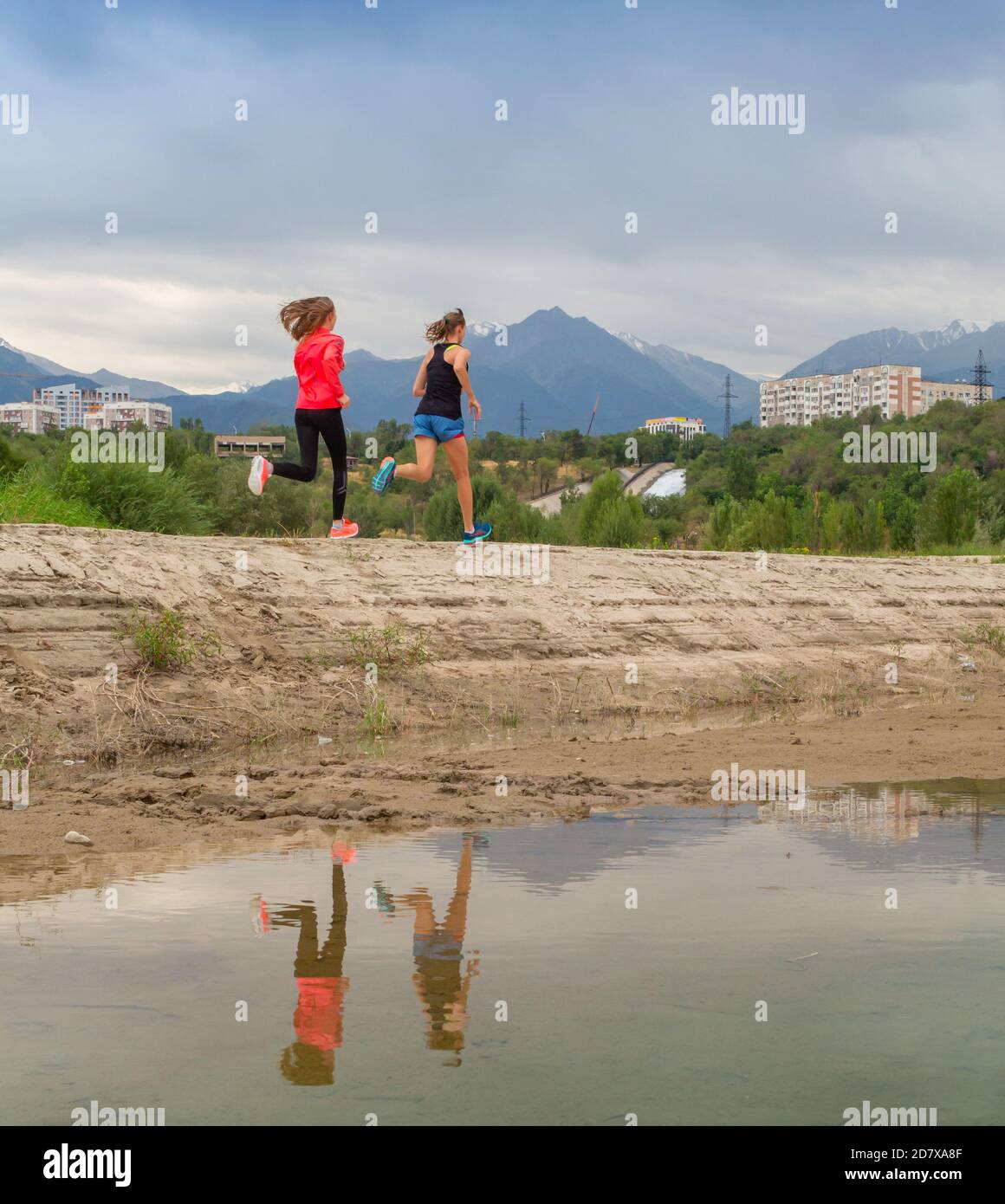 Two beautiful girls came to the city park in new sportswear to go ...