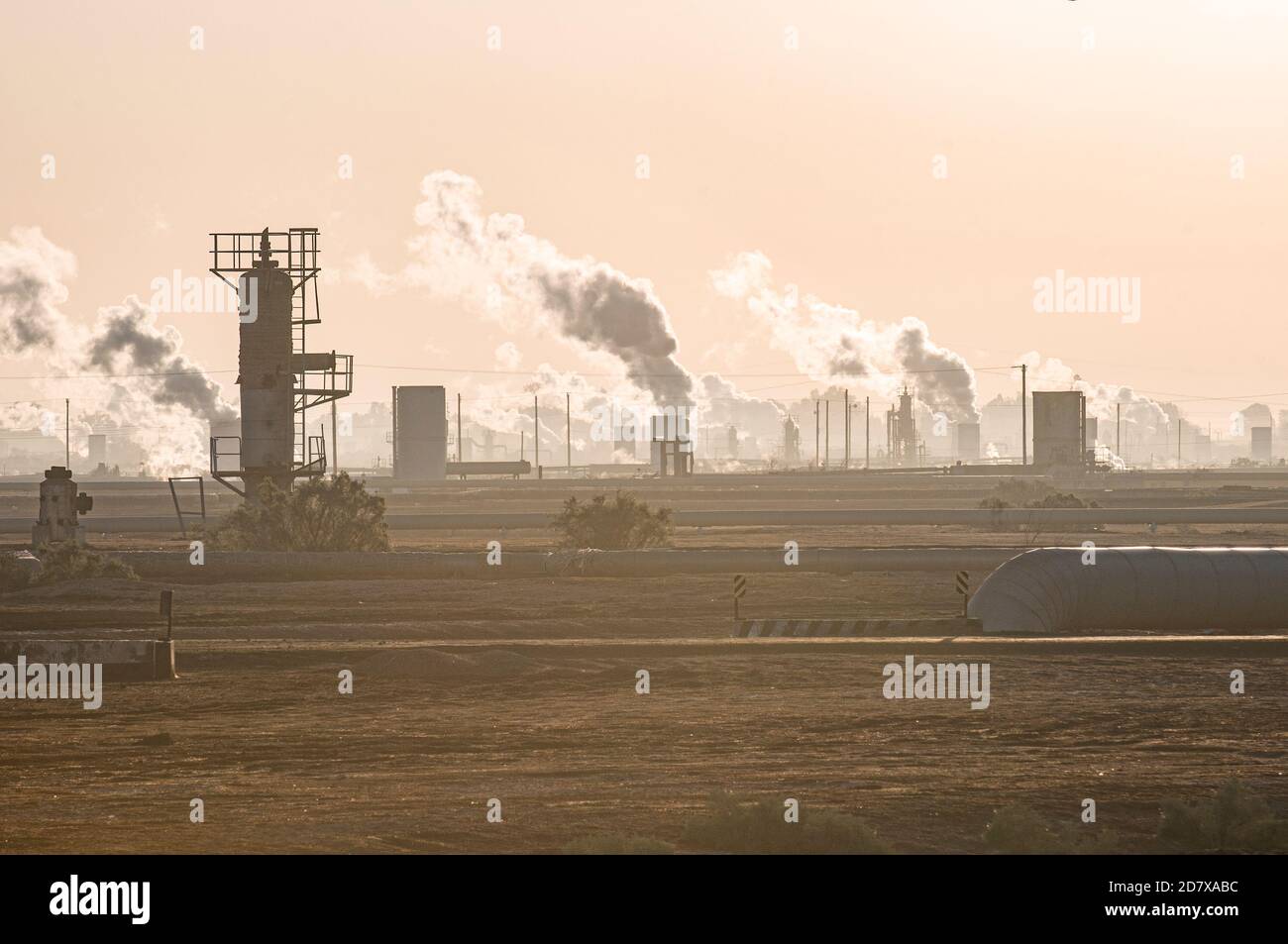 Sunrise in geothermal industrial field, with steam and vapor pipes, in ...