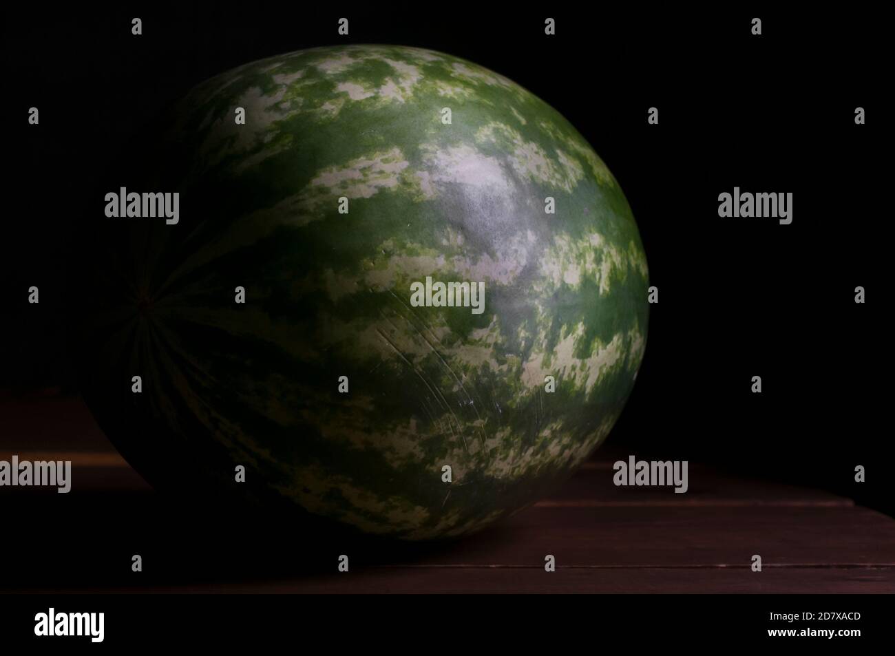 chiaroscuro still life watermelon on a wooden table, baroque ...