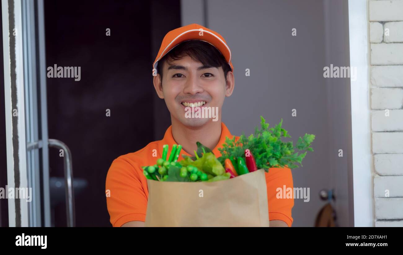 The delivery staff brings the products to customers at home Stock Photo ...