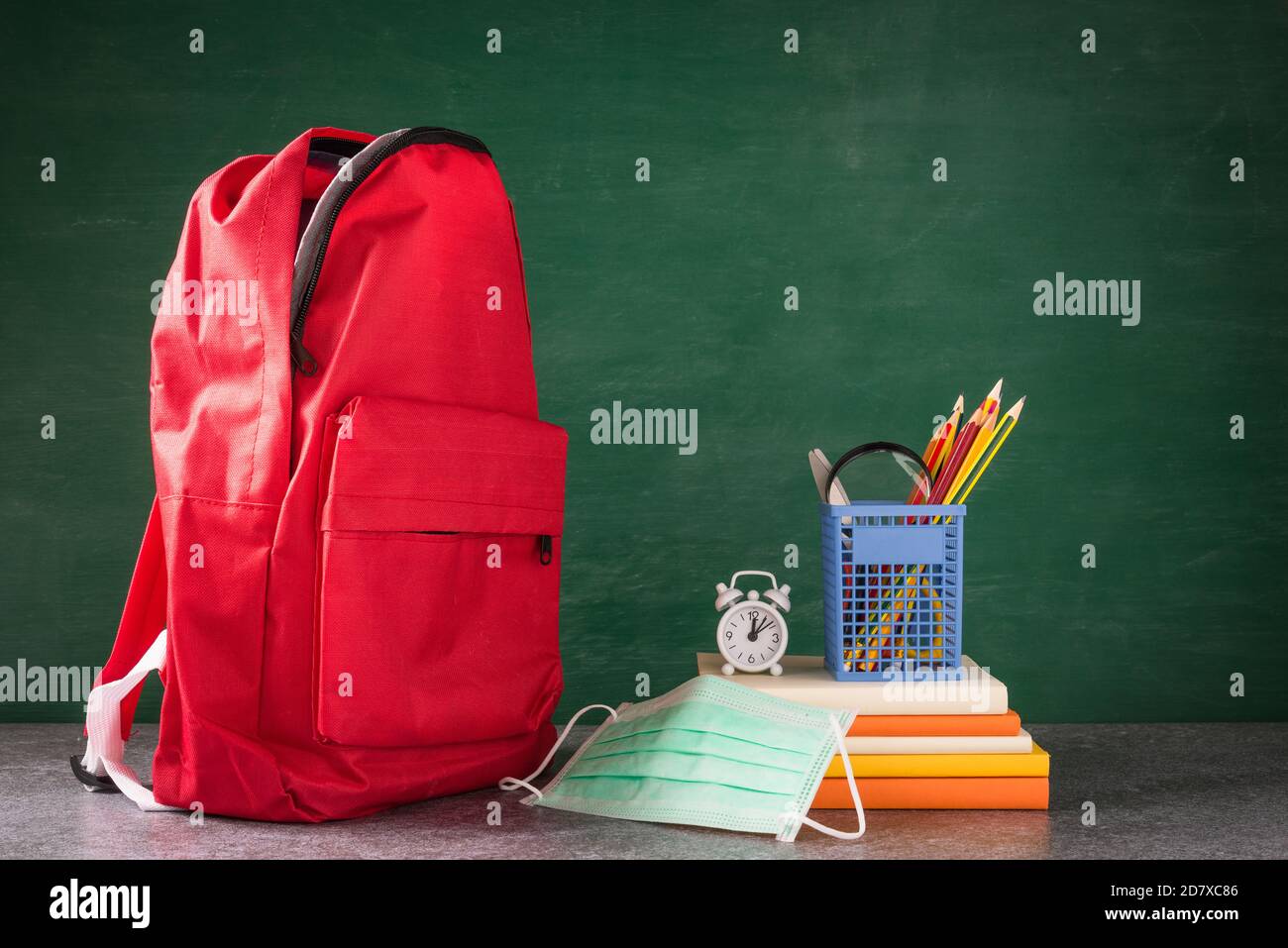 Front school backpack and accessories with face mask protect on table ...