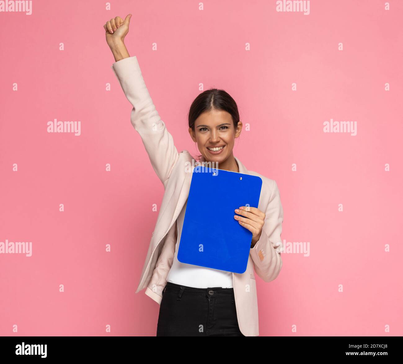 attractive businesswoman giving a thumbs up high in the air and holding ...