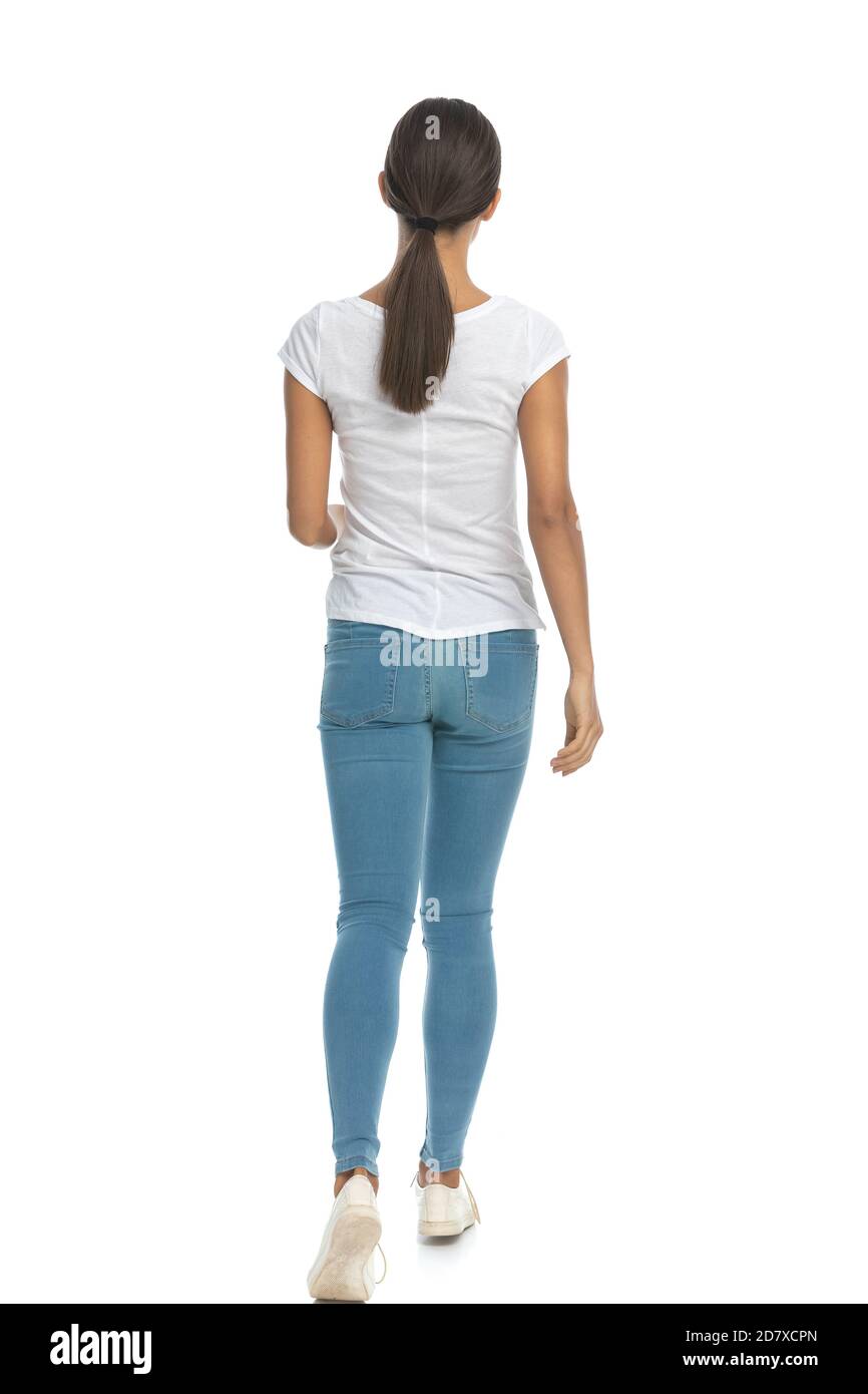 Back view of casual woman walking on white studio background Stock ...