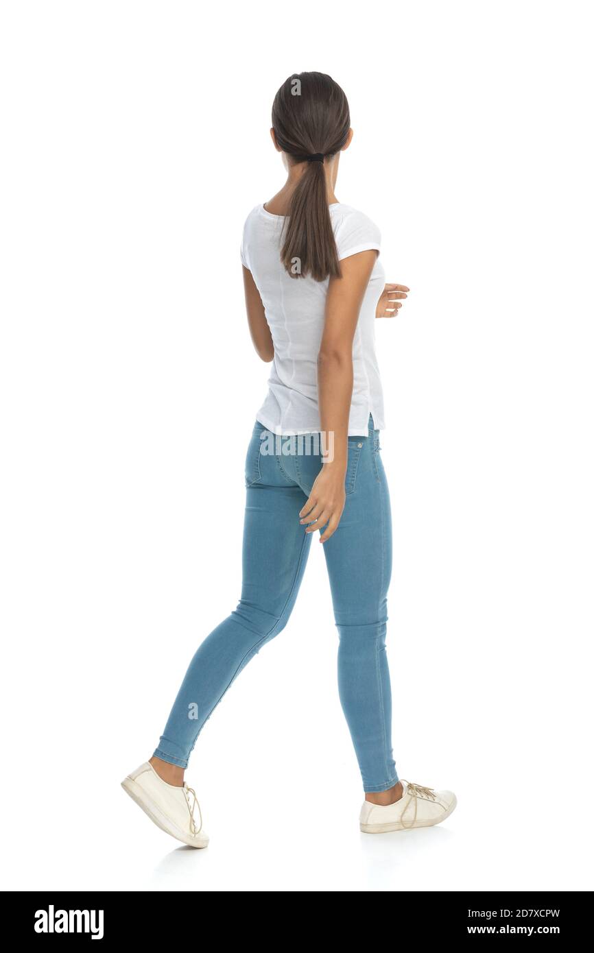 Side back view of casual woman walking on white studio background Stock ...