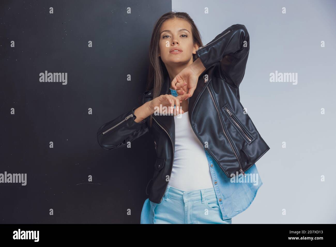 Charming fashion model holding hands together and smiling while ...