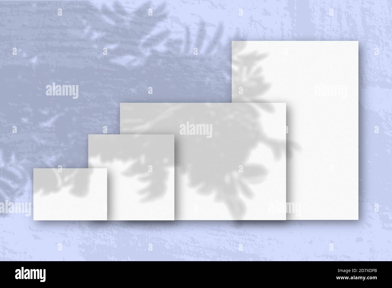 Several horizontal and vertical sheets of white textured paper against ...