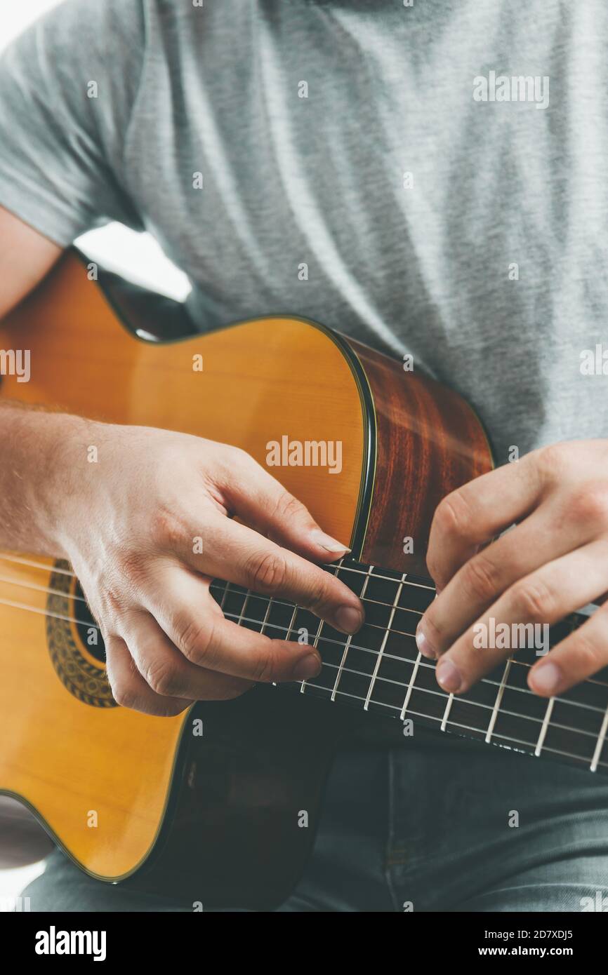 Close-up on the hands of a guitarist playing classical guitar in two ...