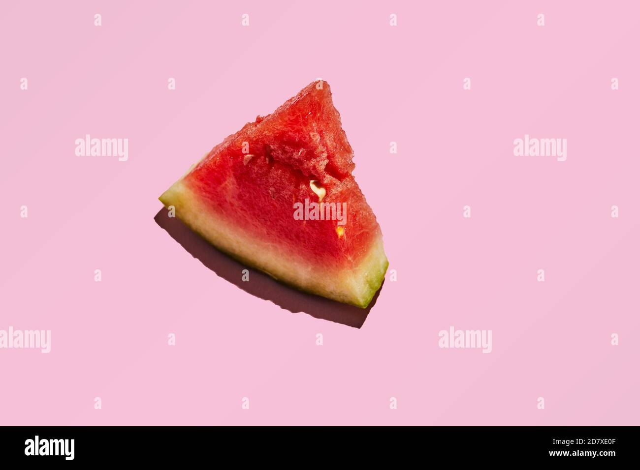 Slice of Mini Watermelon isolated on pink background with hard shadow ...